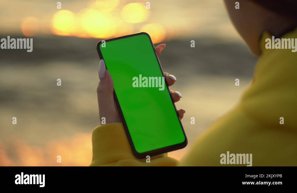 Handheld Camera: Point of View of Woman at beach Using Phone With Green ...