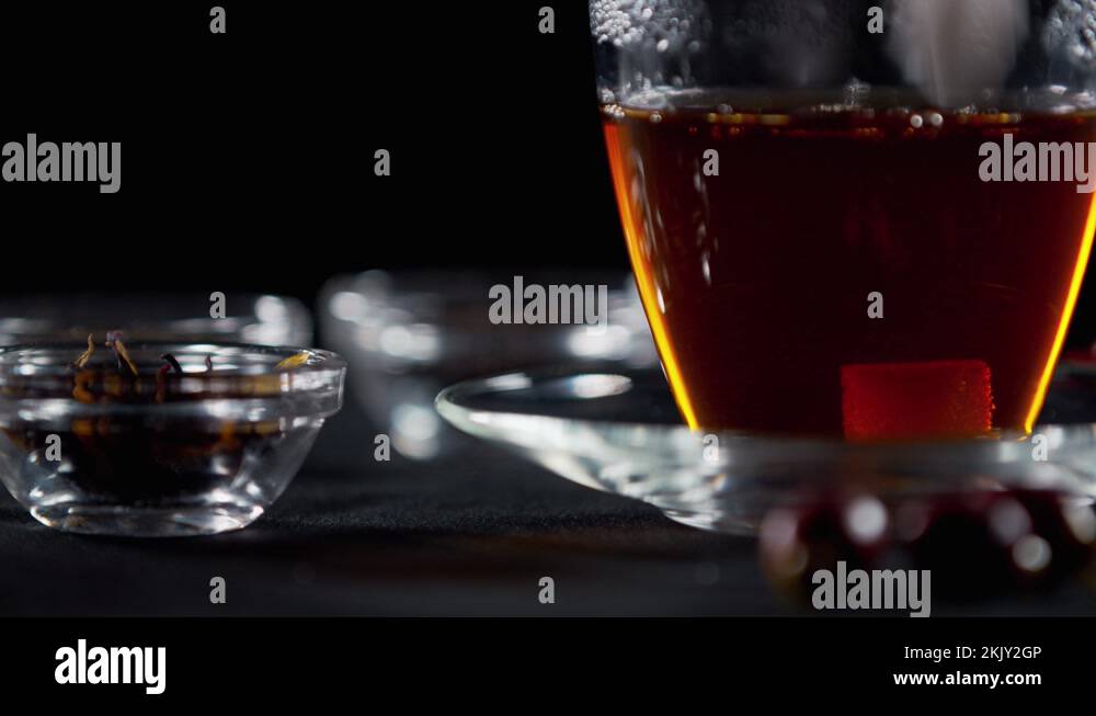 Dropping lump sugar into the hot tea, refreshing beverage, 4k Stock ...