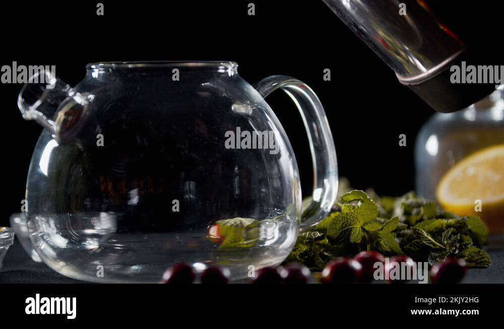 Making tea, pouring boiling water into a transparent teapot, 4k Stock ...