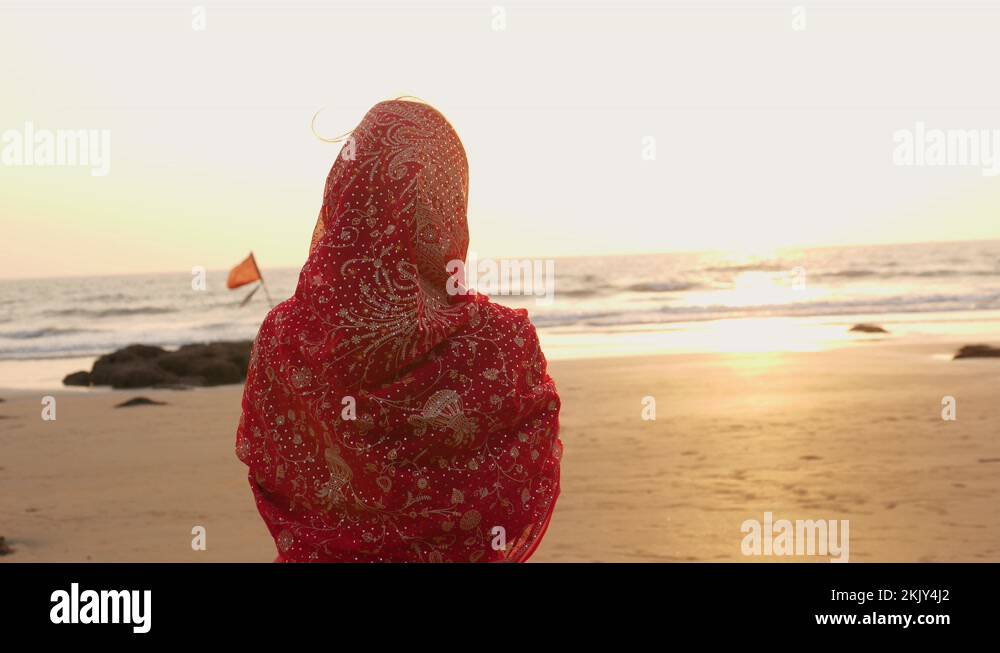 Young women wearing a red saree on the beach goa India.girl in ...