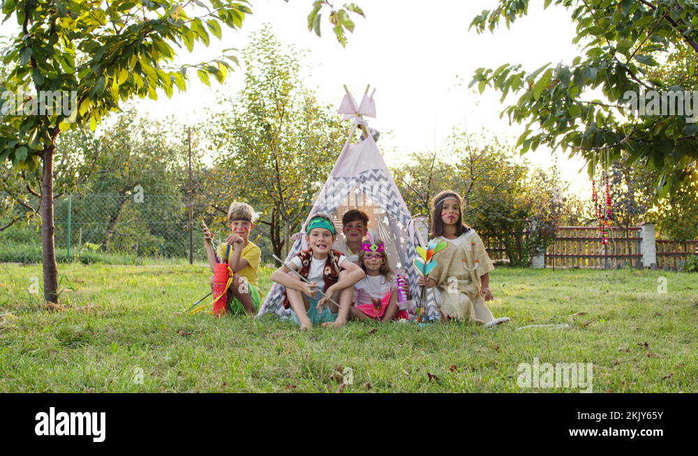 Five Children Play Indians. Three Boys And Two Girls Are Sitting In ...