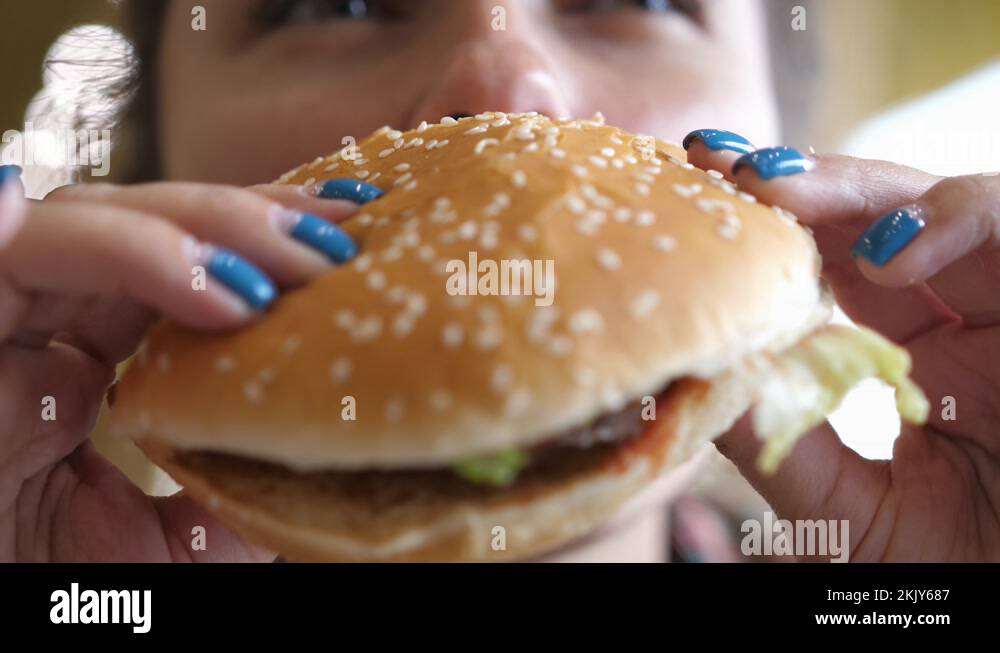 Young Hungry Woman Biting Vegan Meatless Burger in Fast Food Restaurant ...
