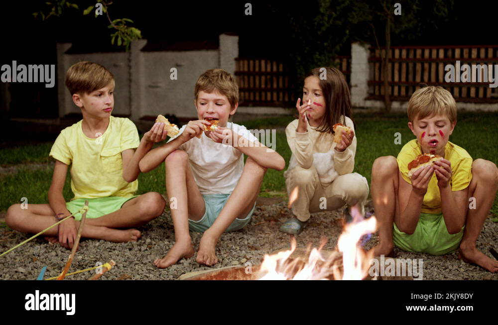 Children Sit By The Fire On The Street And Eat. They Are Tired Of ...