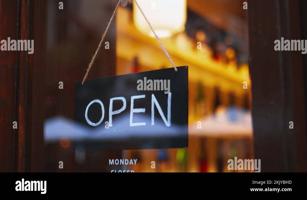 Close up view of an Open sign hanging on the glass door of a Japanese ...