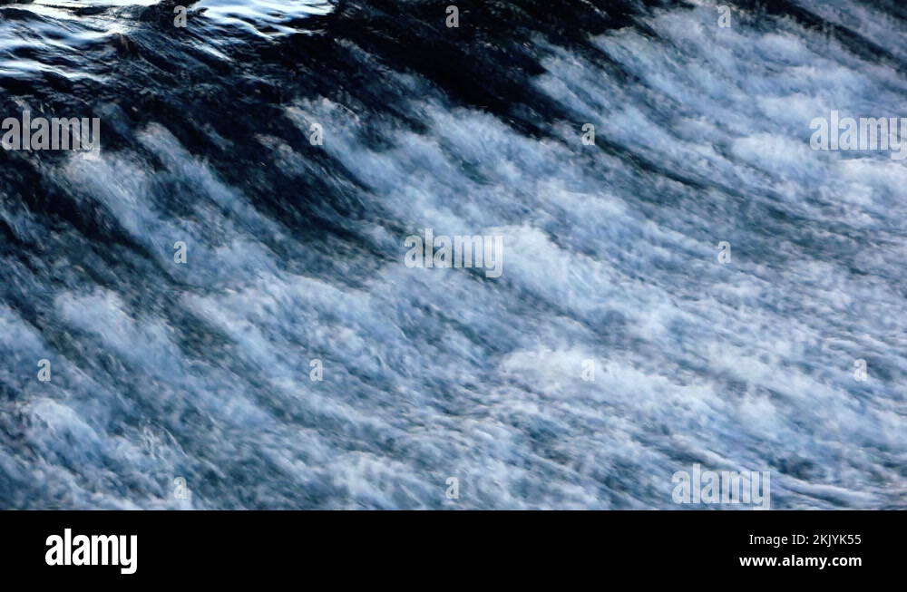Close-up foot of the waterfall. Rapid waters of the dam. Cold fast ...