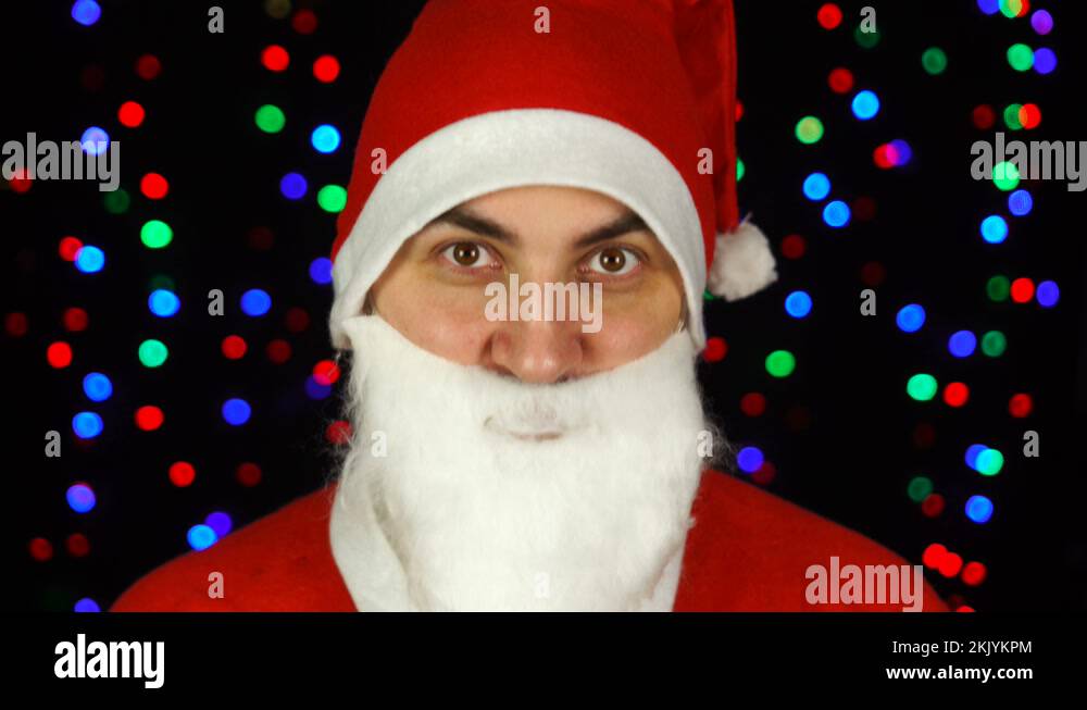 Funny man in a suit of Santa Claus shaking his head up and down and say ...