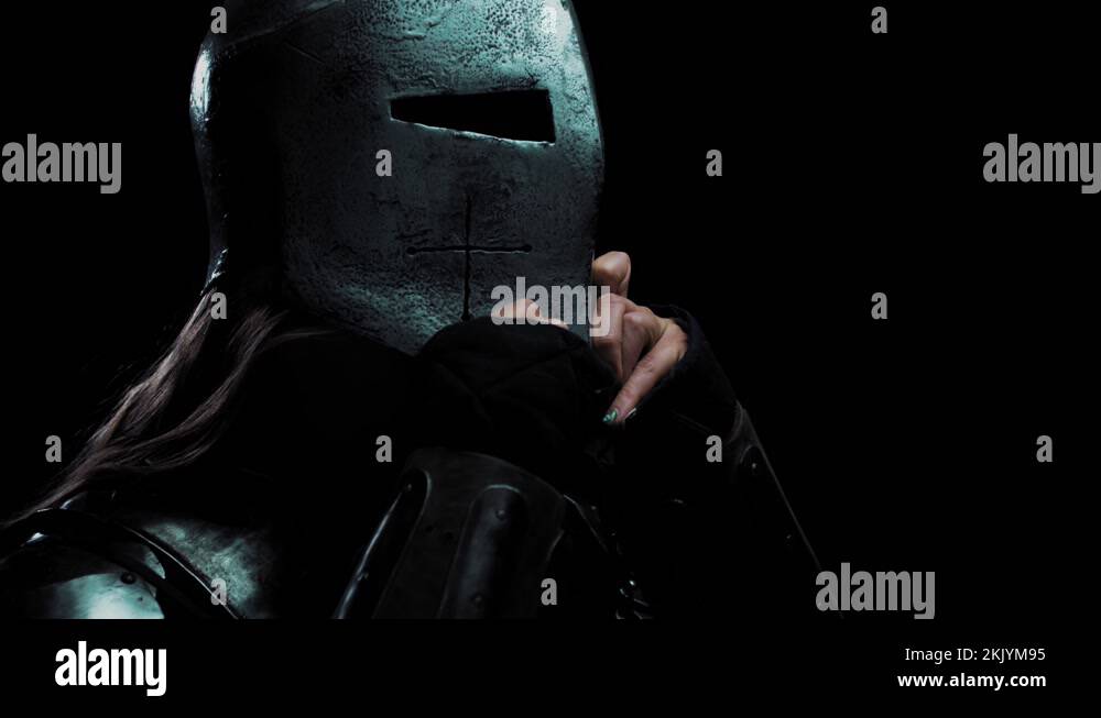 Brave woman is armoring up before battle, putting on the helmet, 4k ...