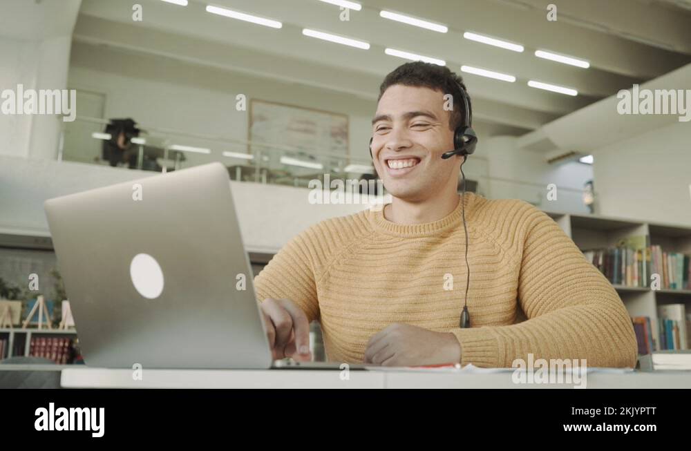 smiling handsome latinos man communicates via video link with a headset ...
