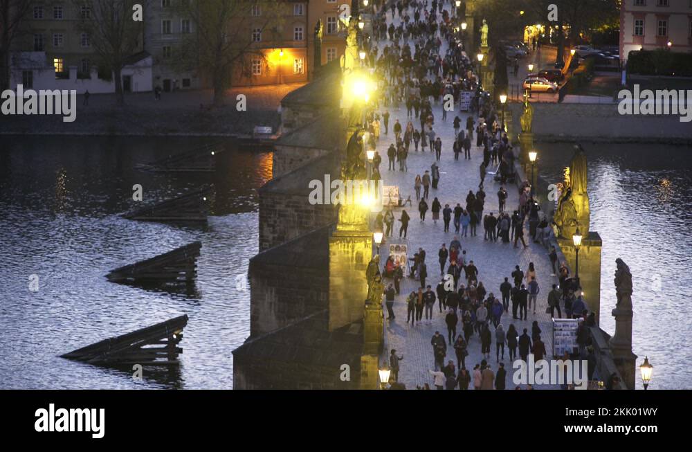 people silhouettes wander along illuminated Charles Bridge Stock Video ...