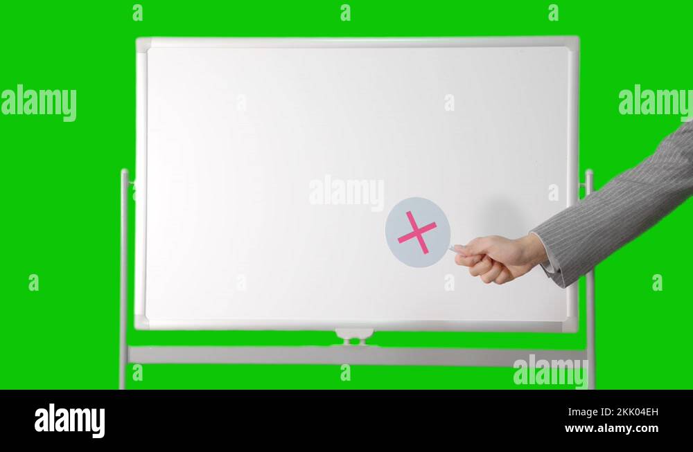 Man showing a cross sign plate. Green background for chroma key ...