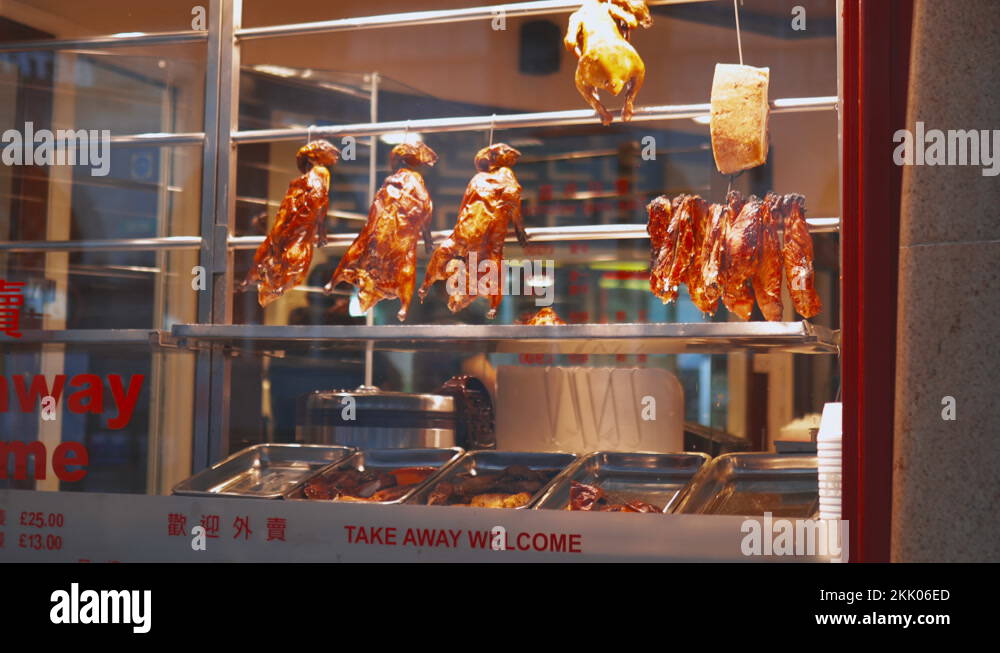 Roasted meat hanging behind the window of a Chinese restaurant Stock ...