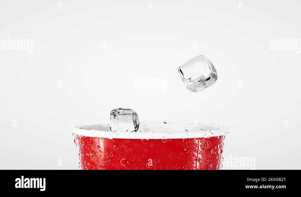 Close-up Liquid Splash with Drops Ice Cubes in a Red Cola Drink on ...