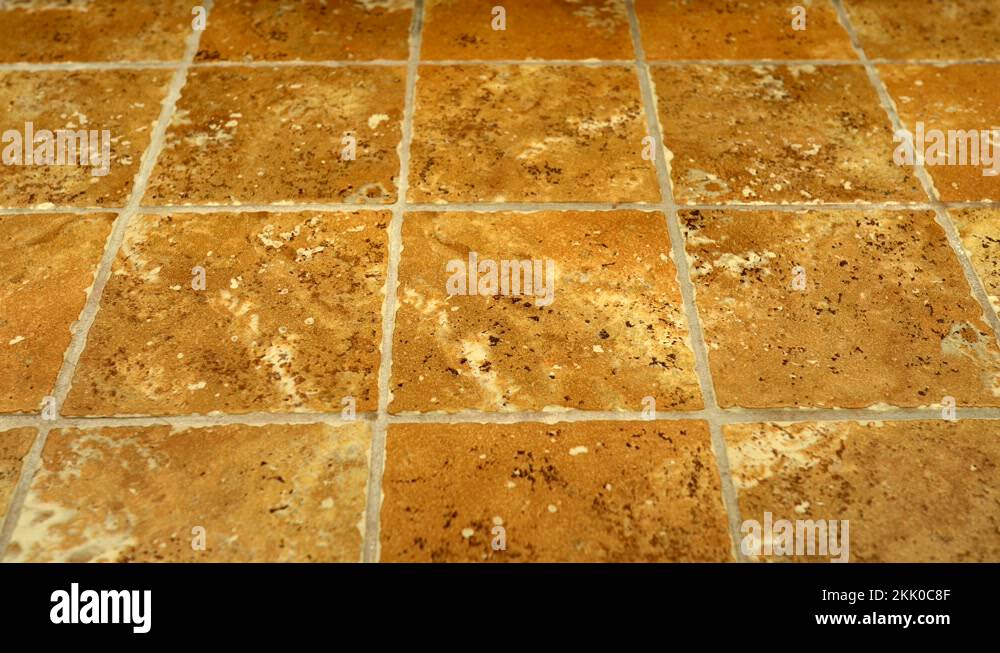 Installed ceramic floor tiles - brown and yellowish textures. Square ...