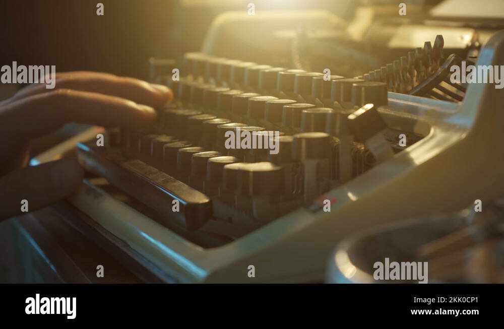 Guy types on an old typewriter and smokes cigarettes, writer ...