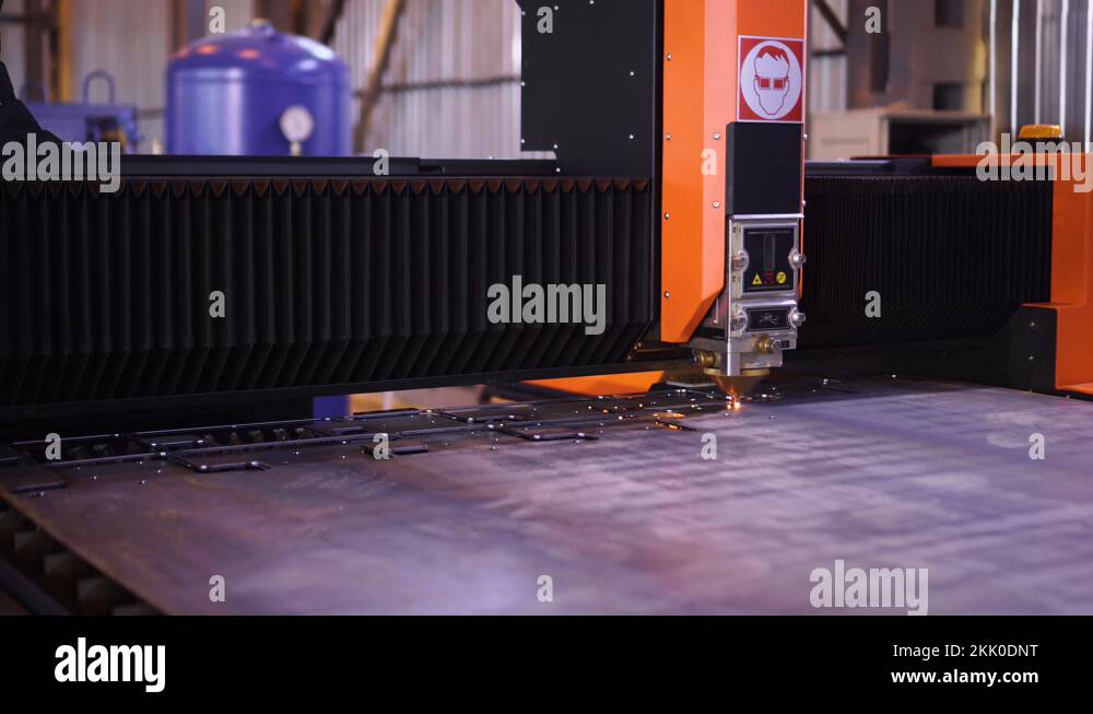 Fiber laser cutting CNC machine making holes in metal list sheet ...