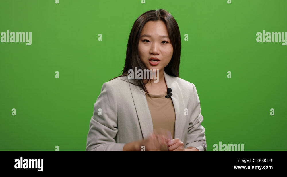 Television news reporter talking during an ad. Female anchor turning ...