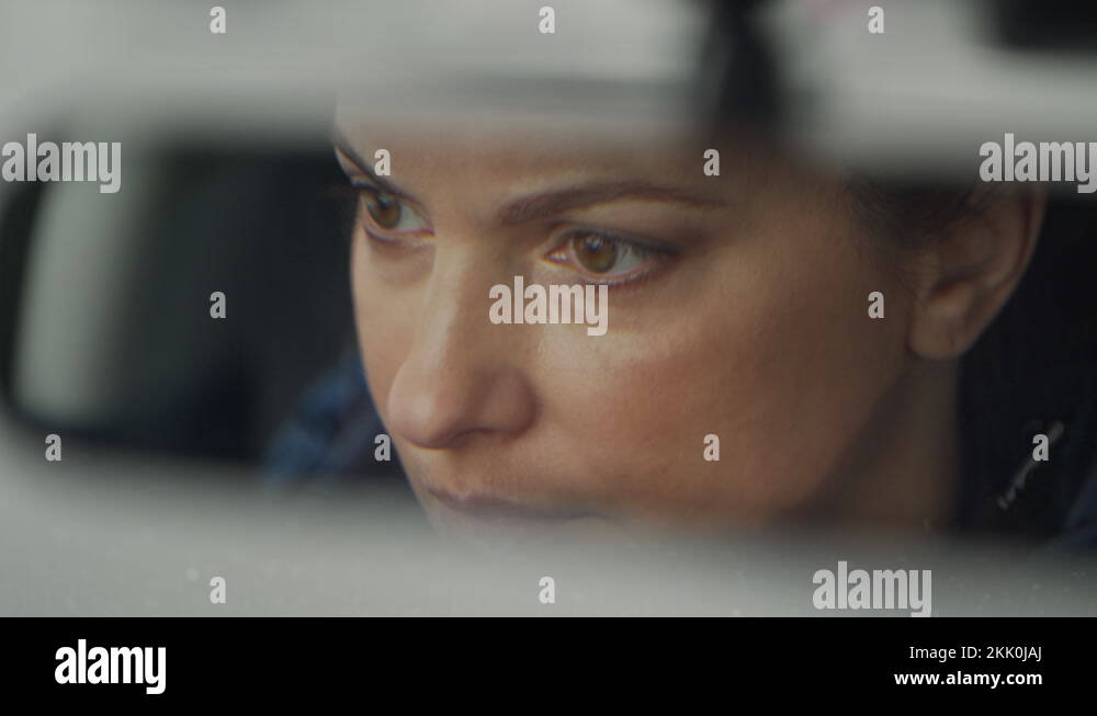woman sitting behind the wheel driving car female face in rear view ...