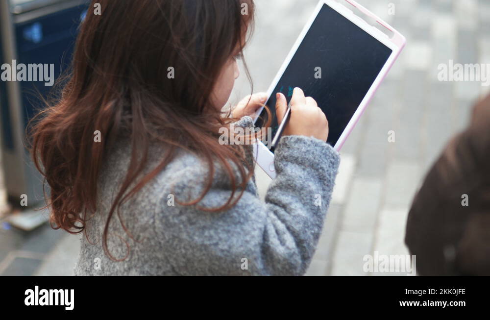 Concentrated little girl drawing stick figures on a tablet Stock Video ...