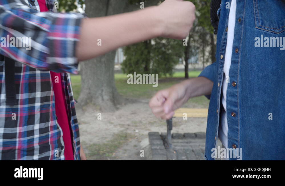 Modern handshake of two schoolboys outdoors. Unrecognizable Caucasian ...