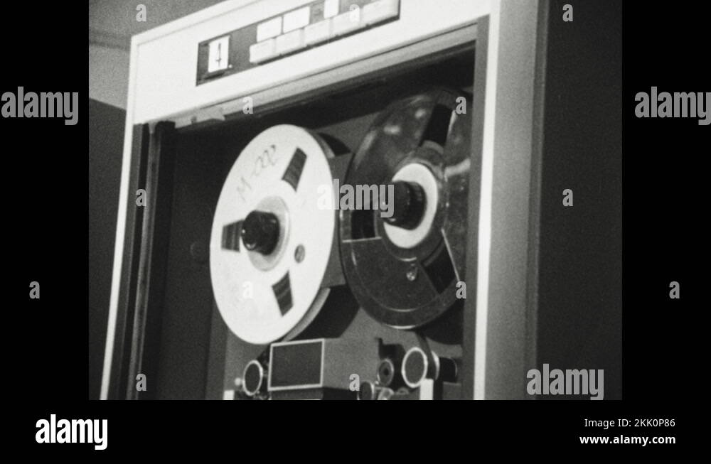 1960s Baltimore: Punch card is fed into mainframe computer. Printout on ...