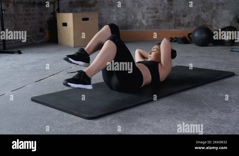 Shot of young sports Indian girl doing crossed leg and hand rise Stock ...