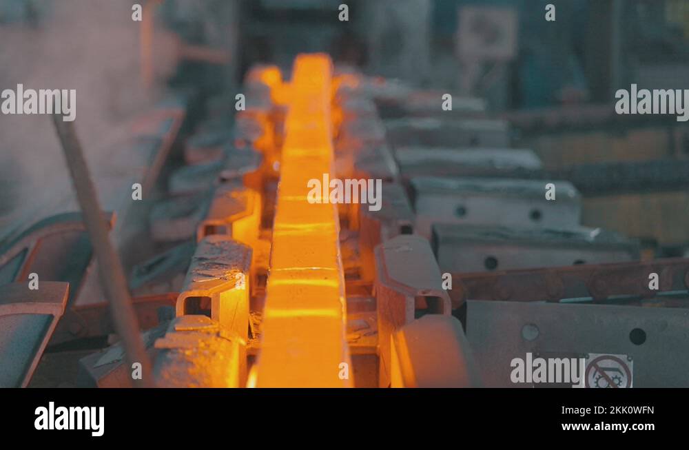 Hot metal on a conveyor line. Red hot metal. Production of rolled metal ...