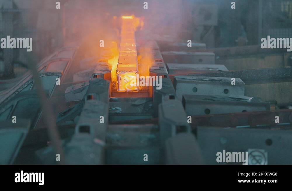 Hot metal on a conveyor line. Red hot metal. Production of rolled metal ...