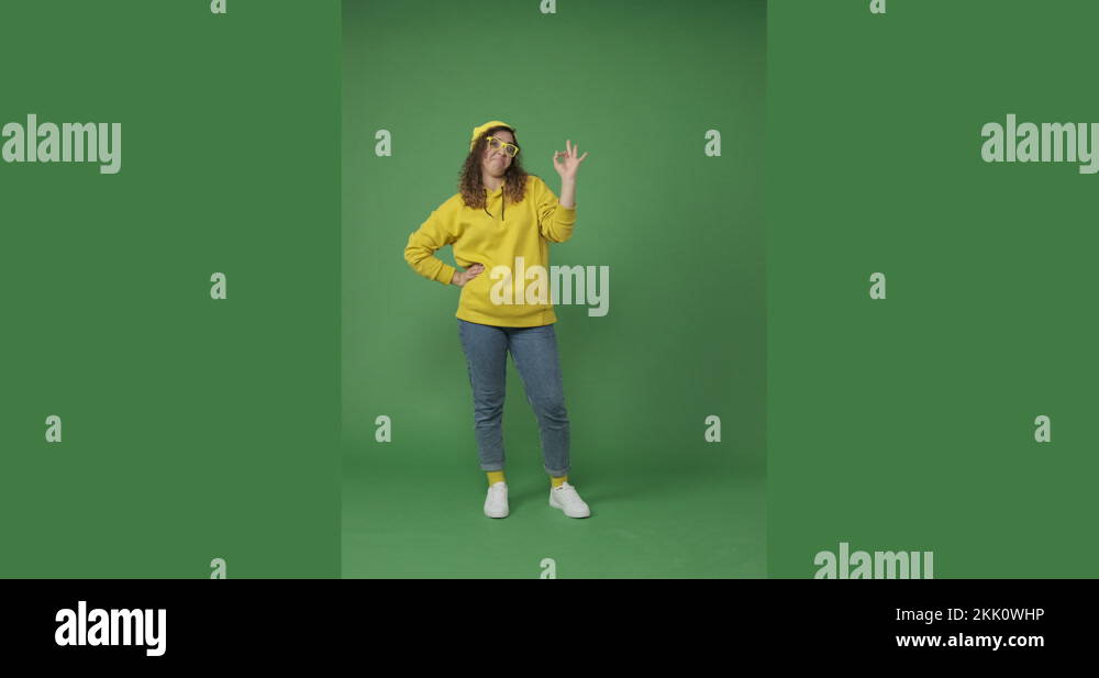 Woman giving thumbs up and ok hand sign over green screen Stock Video ...