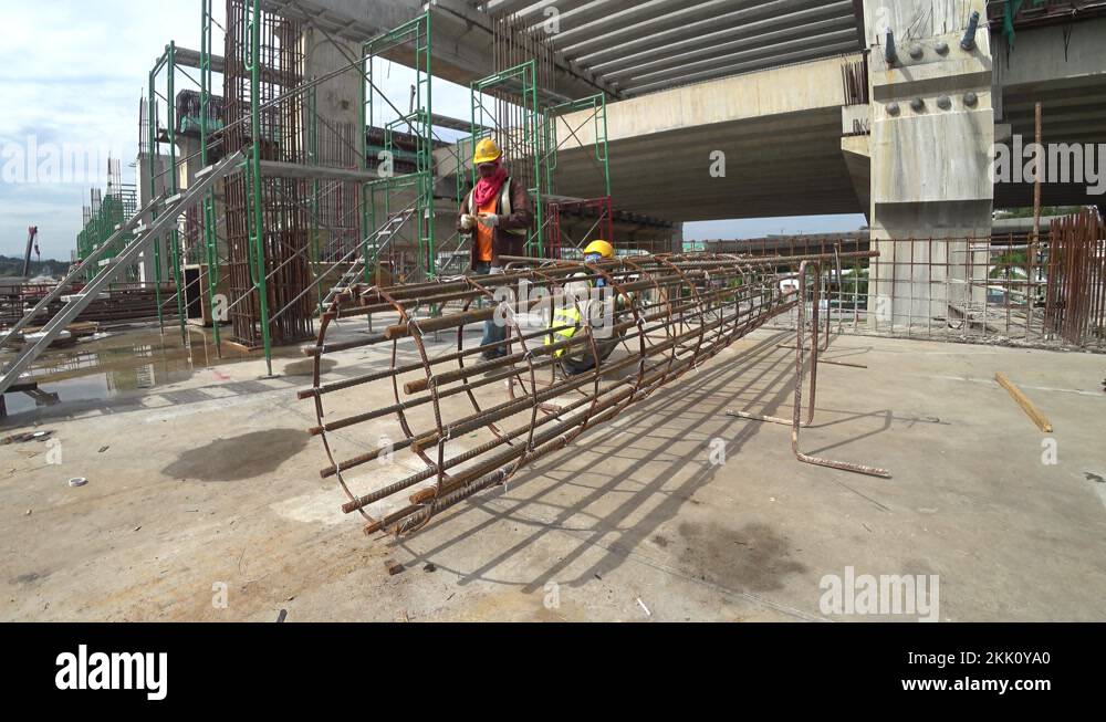 Construction workers installing & fabricating timber formworks and ...