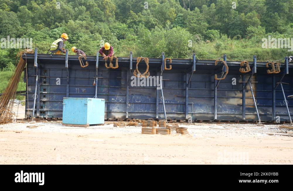 Construction workers installing & fabricating timber formworks and ...