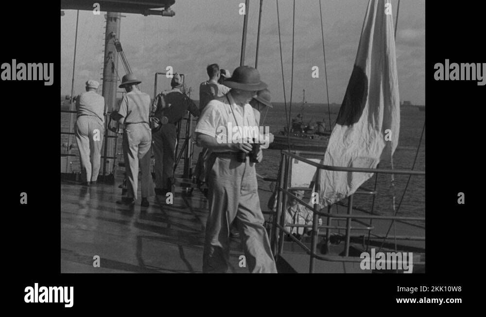 1940s: Soldiers stand on the deck of a ship - some in full uniform ...