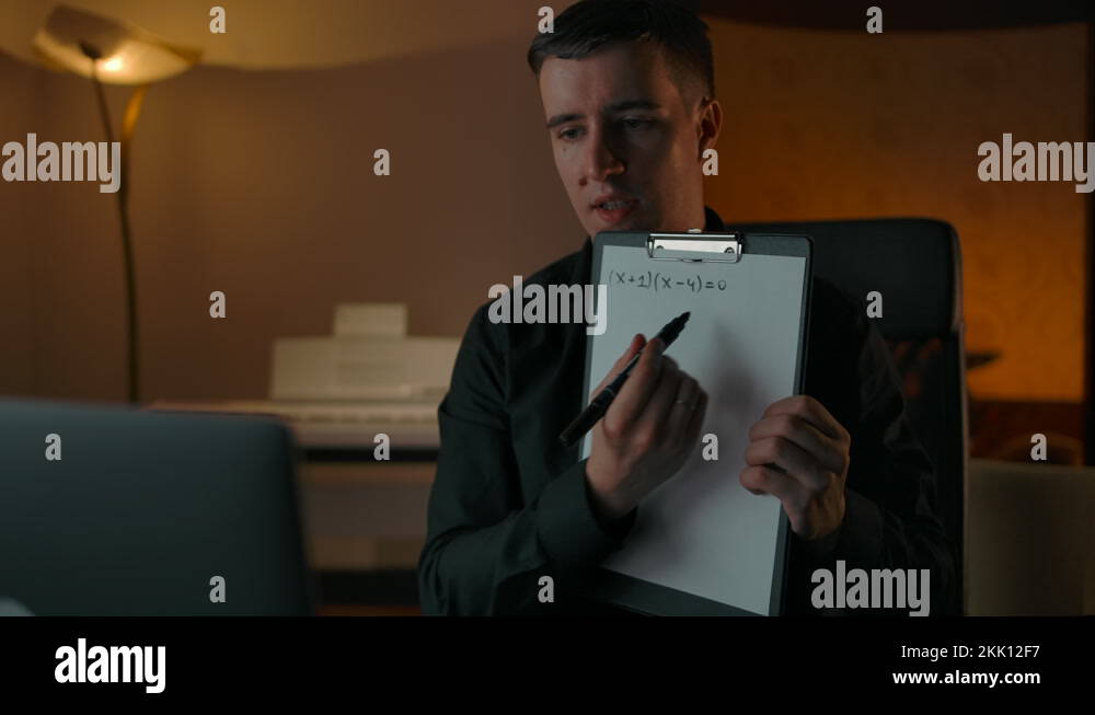 Young teacher explains solving of the math equation online Stock Video ...