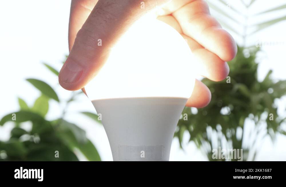 Man Rotates with His Hand a Led Bulb in Its Electrical Socket Opening ...