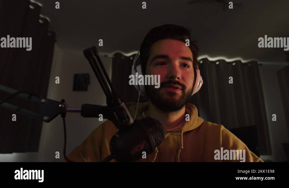 Male gaming on a pc talking into microphone and leaning on hand Stock ...