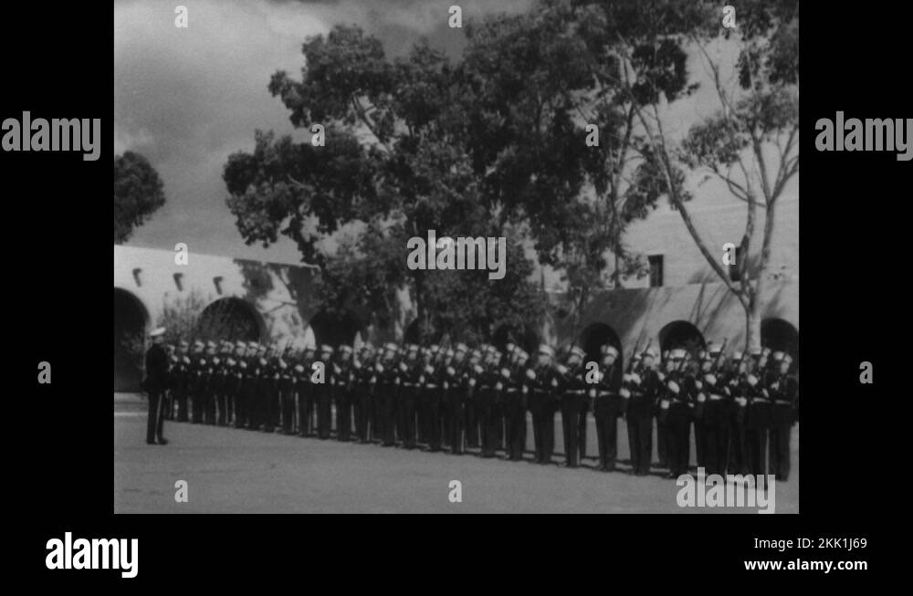 1940s: officer commanding platoon, American flag waving in wind Stock ...