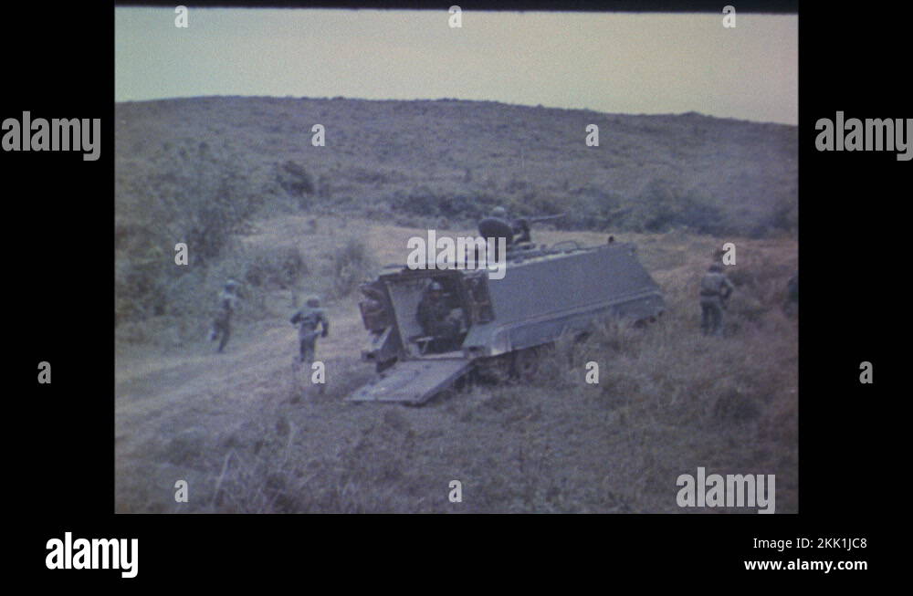 1960s: Soldiers fight in Vietnam. American soldiers walking through ...