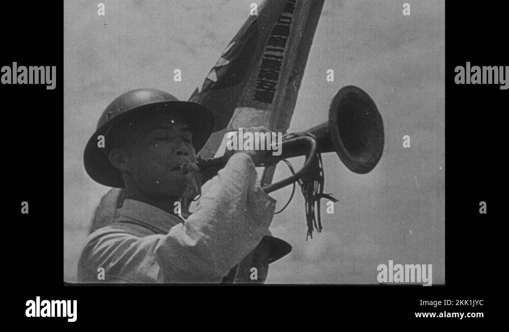 1940s: Soldiers run across field. Soldier blows bugle. Soldiers ...