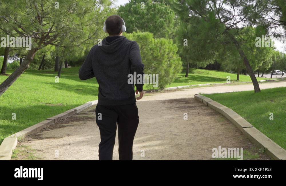 Running man in white helmets and white sneakers with his back to the ...