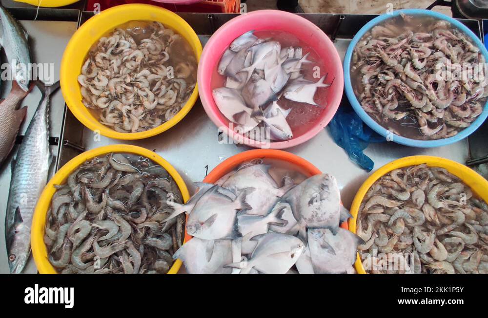 Basins Of Fresh Pomfret Fish And Shrimps At A Stall In A Fish Market In ...