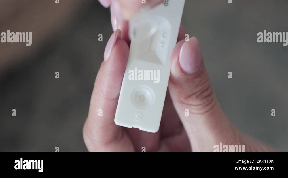 Dropping Lysis Buffer From Test Tube Into Sample Window Of Antigen Test ...