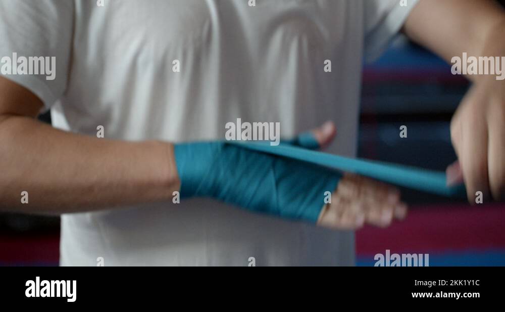 Boxing, training day, boxing gym, a male boxer puts a special bandage ...