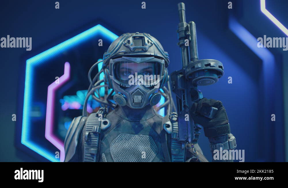 Female soldier of future in futuristic combat suit guards entrance to ...
