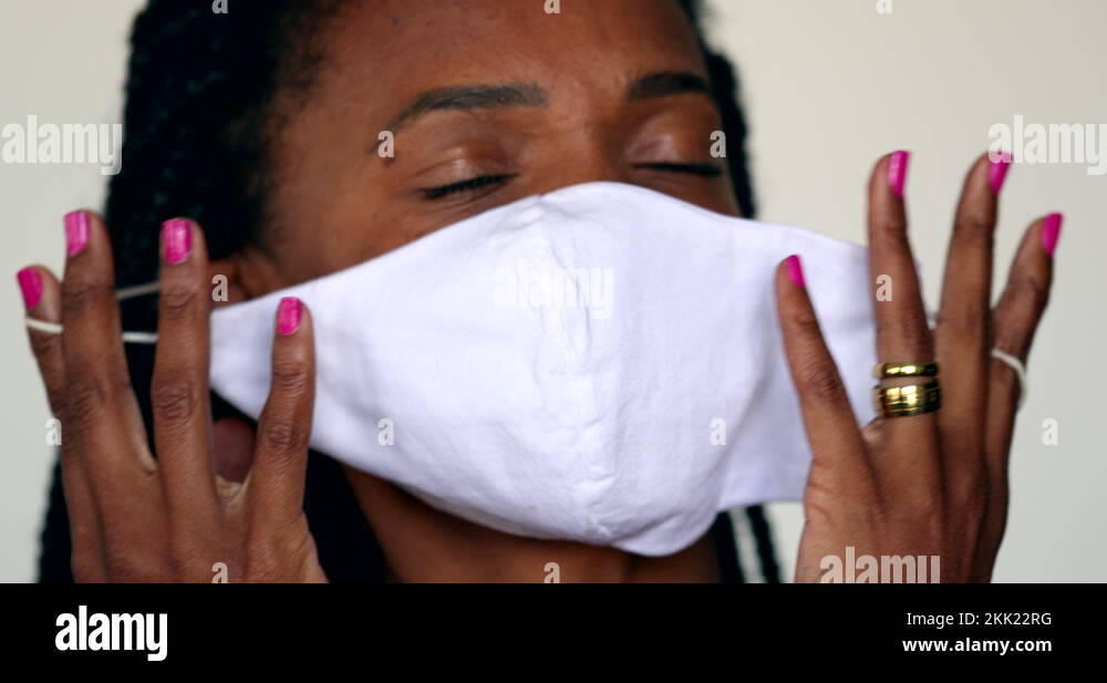 Black Woman removing face mask feeling relief. African person taking ...