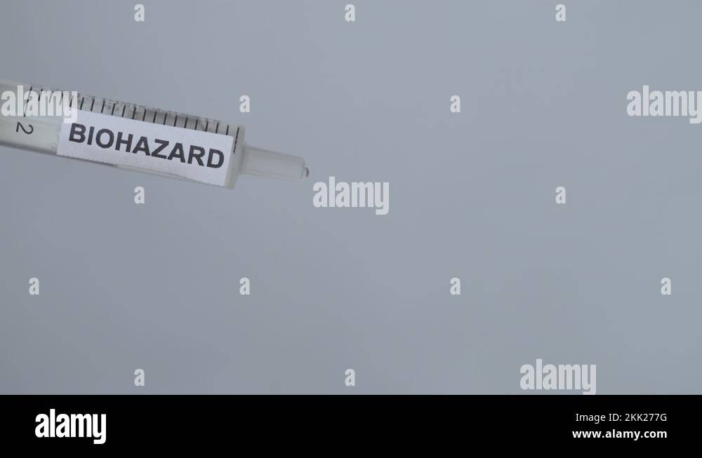 Attaching Hypodermic Needle To Syringe With Biohazard Label ...