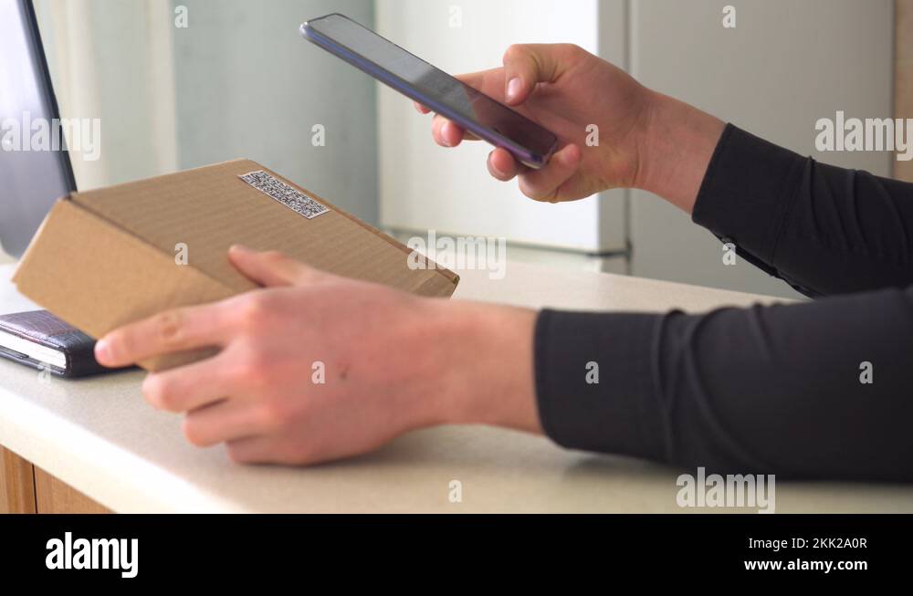 Attaching a QR code to delivery or package. QR code scanning app Stock ...