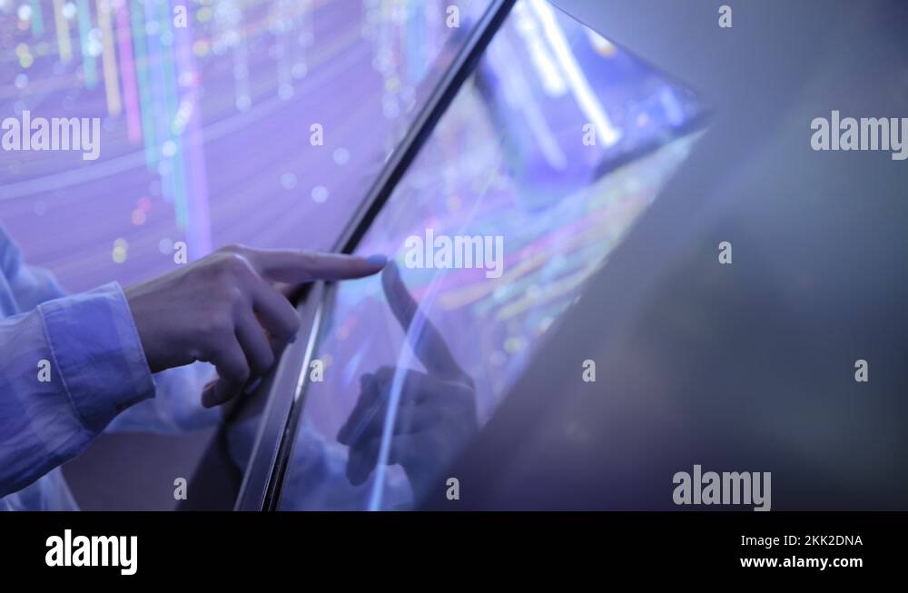 Woman hand using touchscreen display of interactive kiosk at exhibition ...