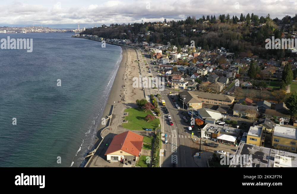 Birdseye footage of Alki Beach, sandy shoreline with a bike / running ...