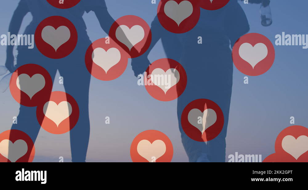 Multiple heart icons floating against couple holding hands and running ...
