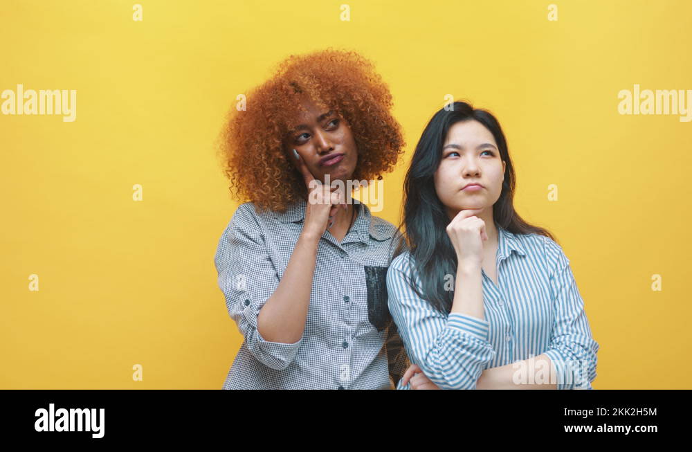Problem solving concept. Two young women questioning chioces they have ...