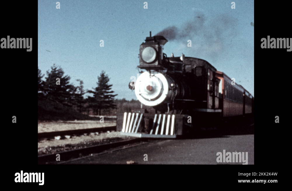 1950s: Locomotive on train tracks. Locomotive pulls by buildings Stock ...